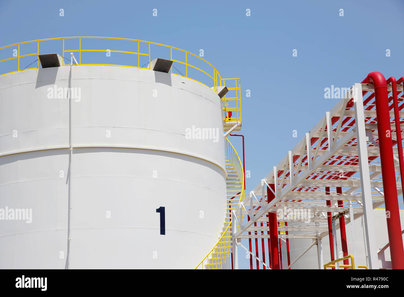 Industrial storage tank with pipes Stock Photo - Alamy