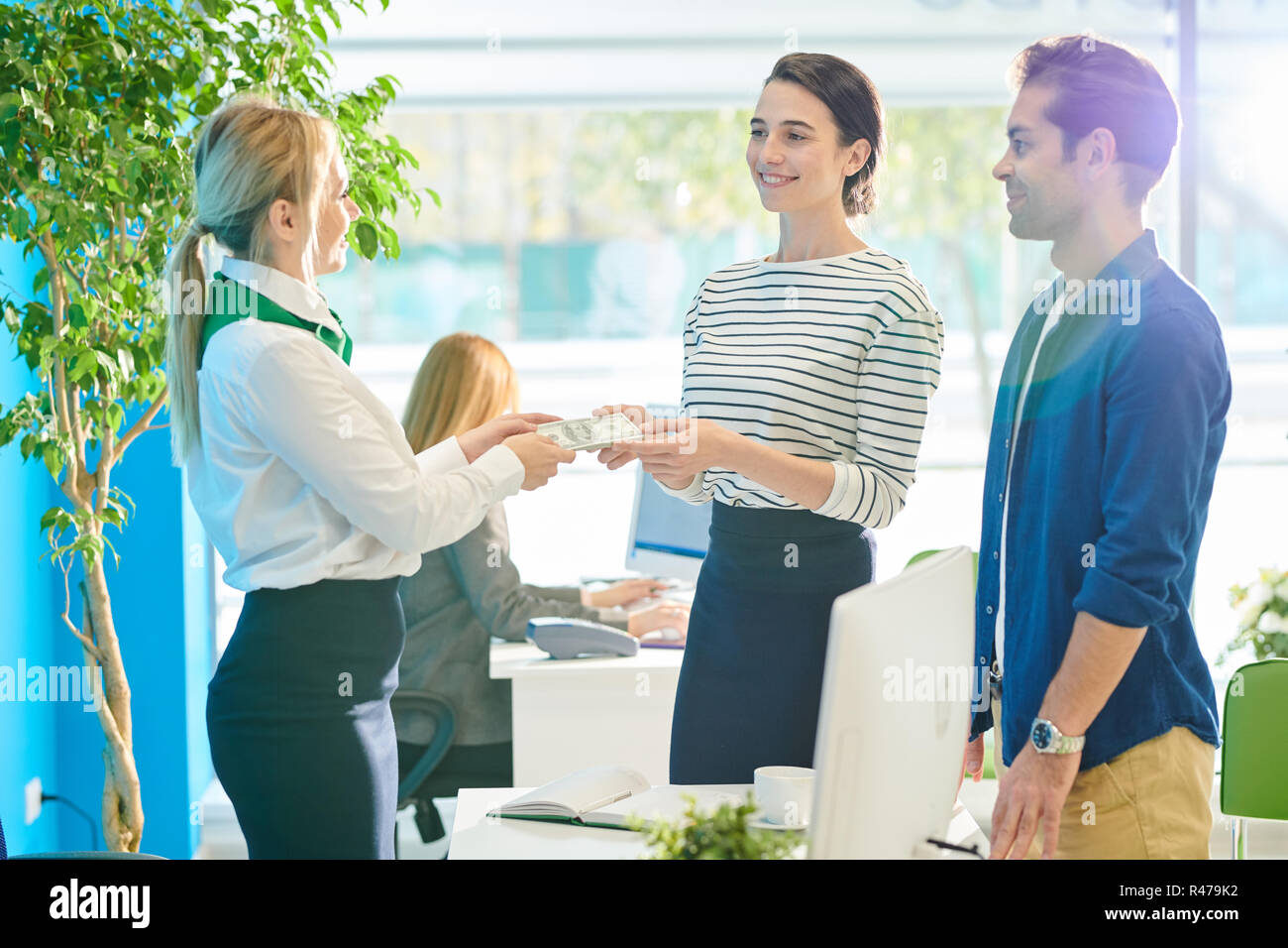 Happy woman receiving money hi-res stock photography and images - Alamy