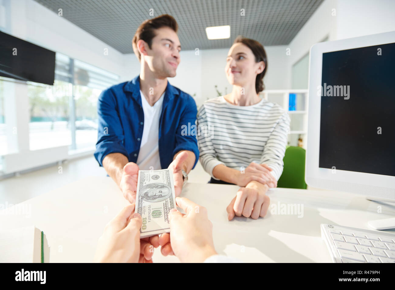 Young man money taking hi-res stock photography and images - Alamy