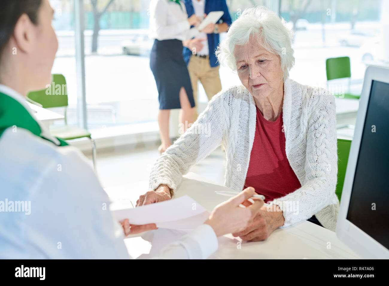 Concentrated senior customer reading confirmation contract Stock Photo ...