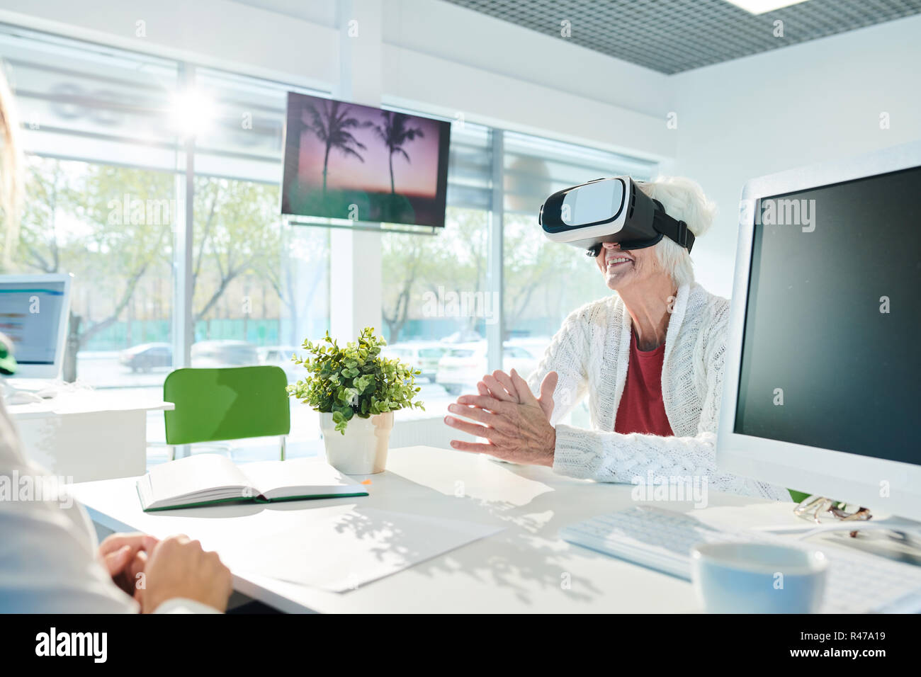 Happy senior lady in VR simulator enjoying virtual tour Stock Photo - Alamy