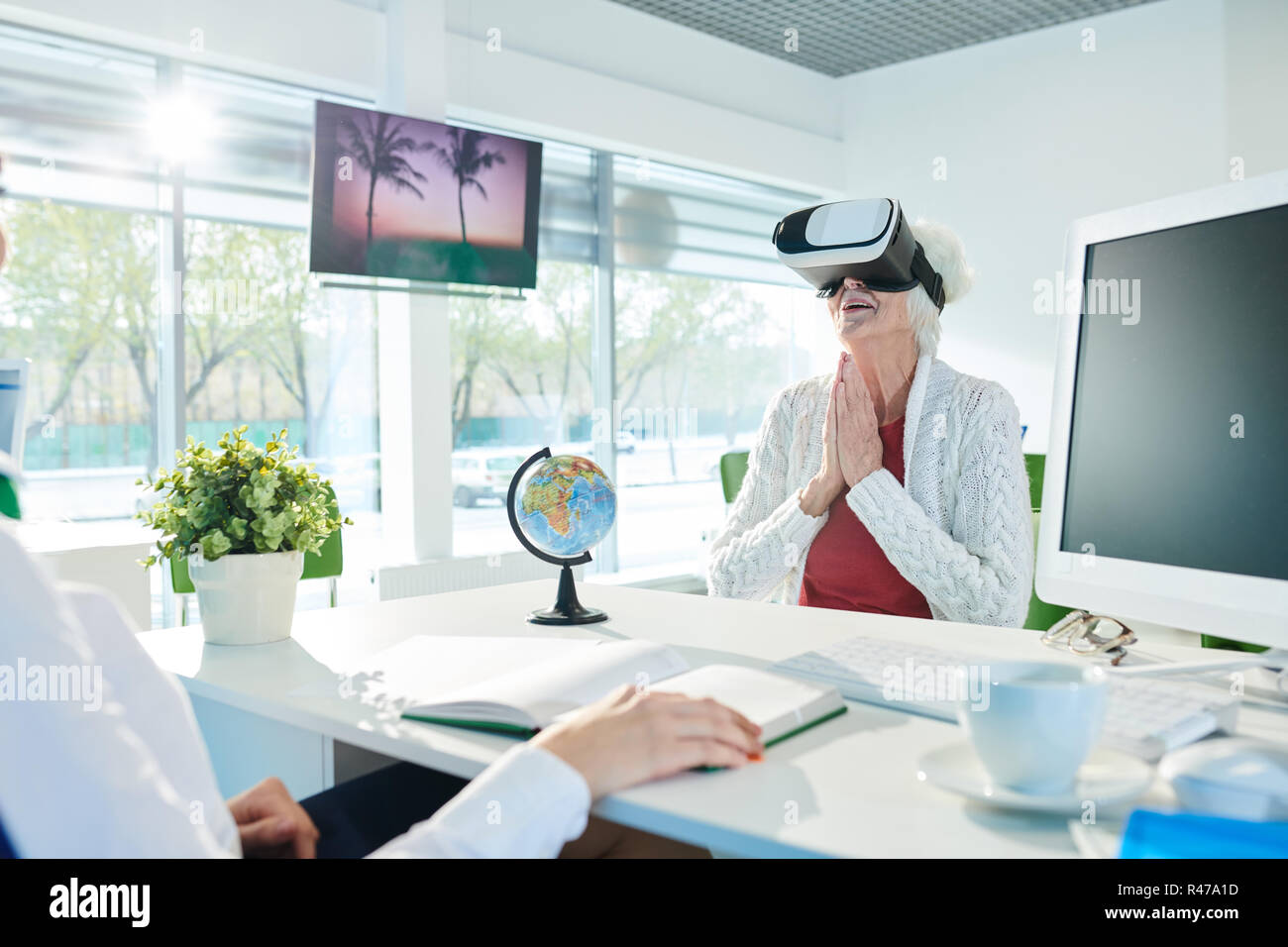 Cheerful senior lady watching 3D video of hotel presentation Stock ...
