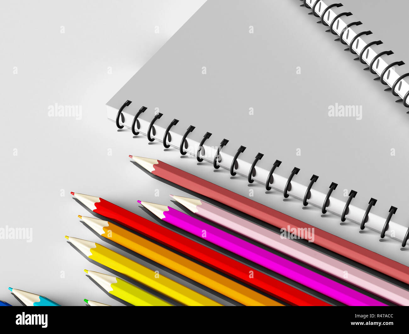 notebook with colored pencils on White background Stock Photo - Alamy
