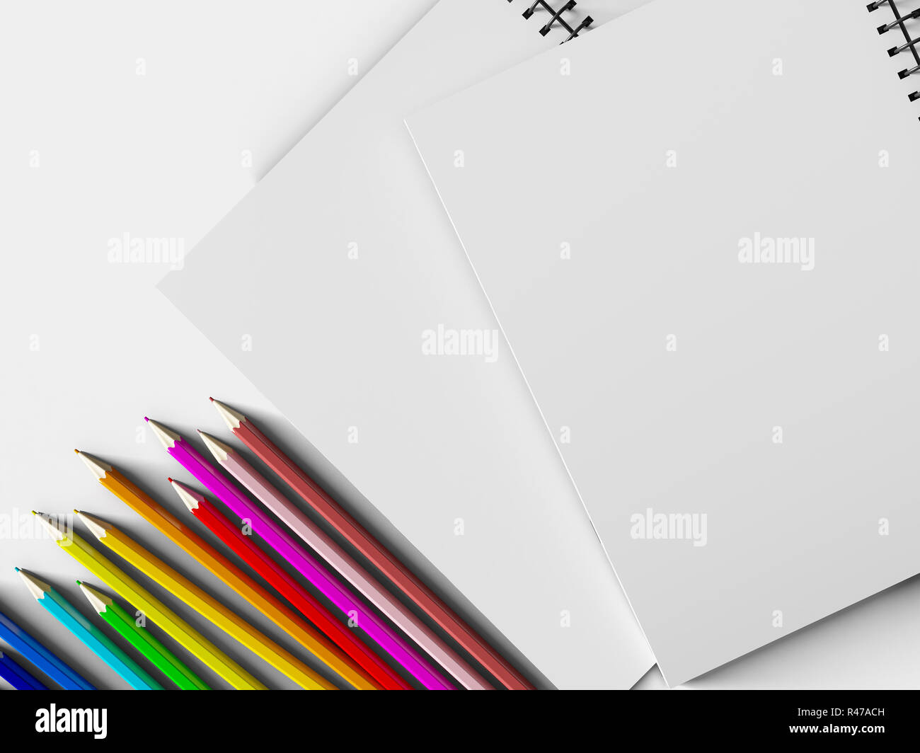 notebook with colored pencils on White background Stock Photo - Alamy
