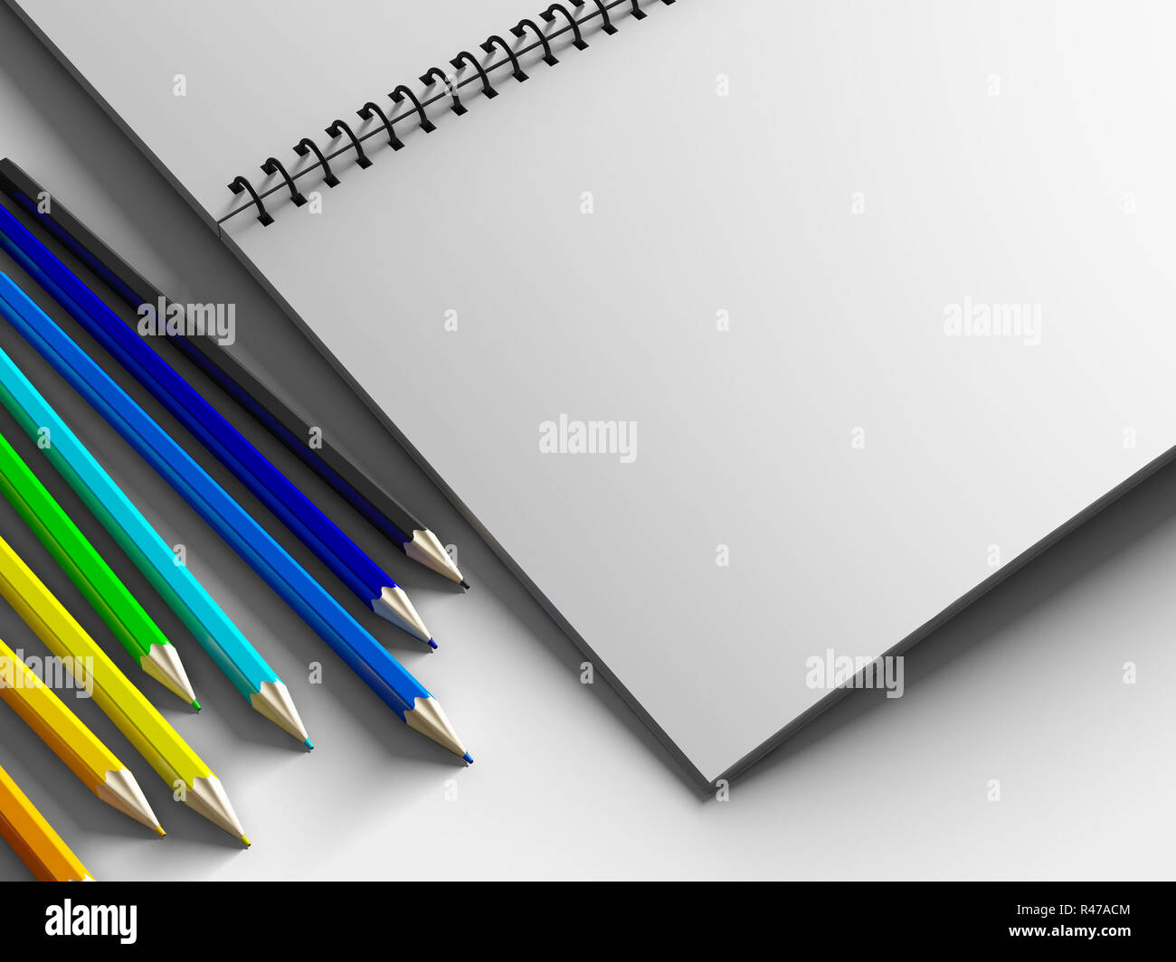 notebook with colored pencils on White background Stock Photo - Alamy