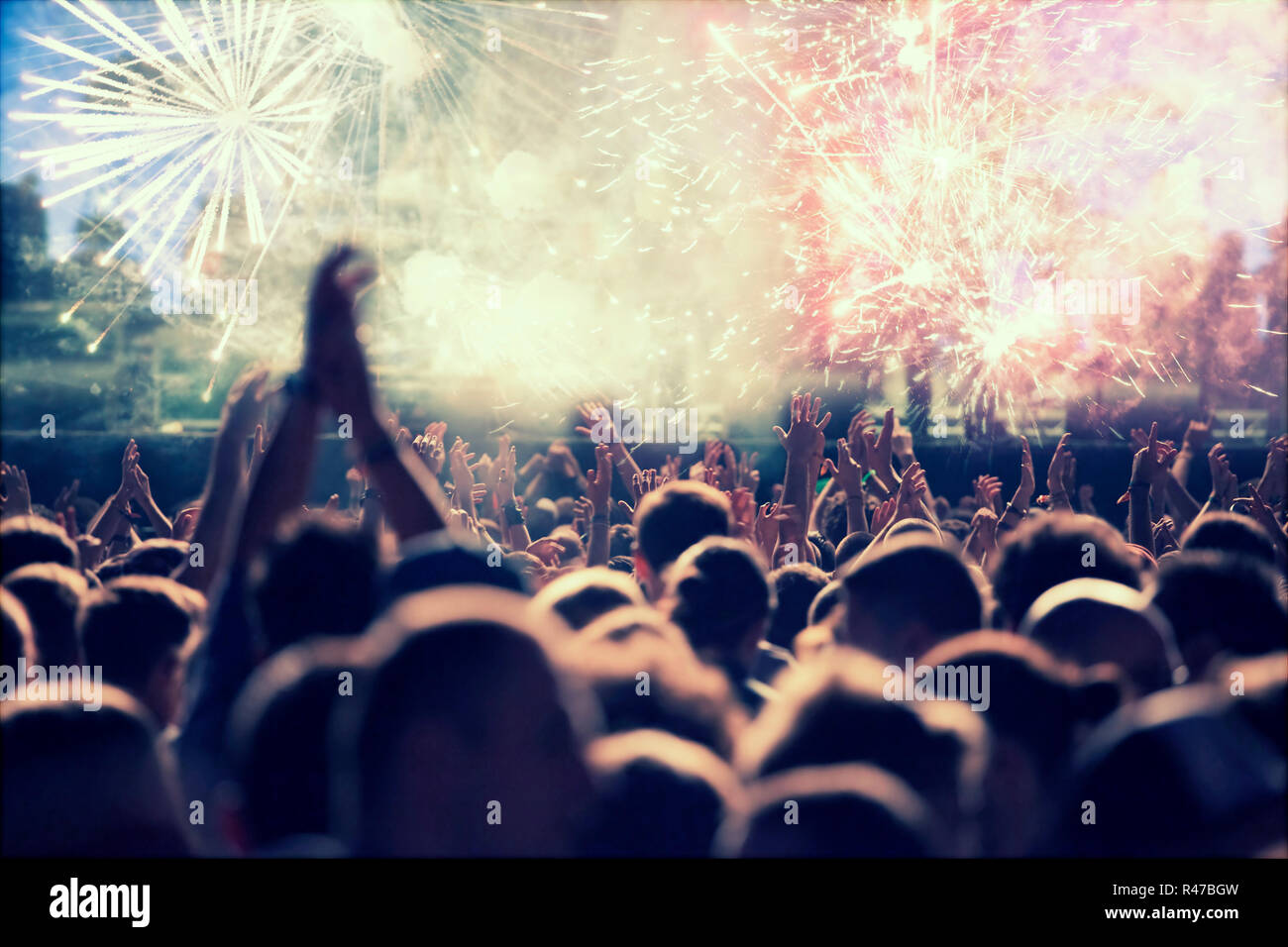 New Year concept - cheering crowd and fireworks Stock Photo - Alamy