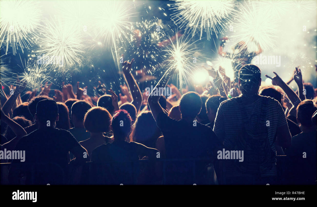 New Year concept - cheering crowd and fireworks Stock Photo - Alamy