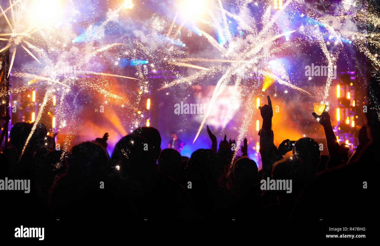 New Year concept - cheering crowd and fireworks Stock Photo - Alamy