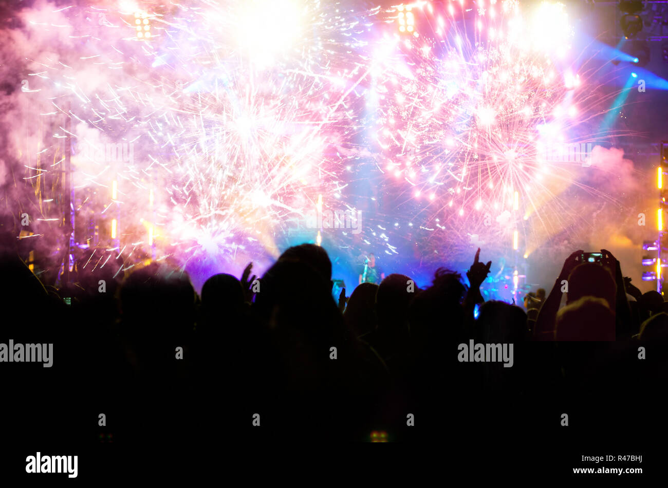 New Year concept - cheering crowd and fireworks Stock Photo - Alamy