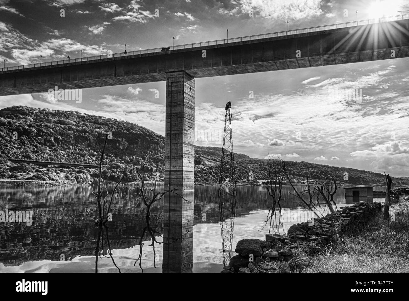 The dam and the bridge on the lake omodeo in black & white Stock Photo ...