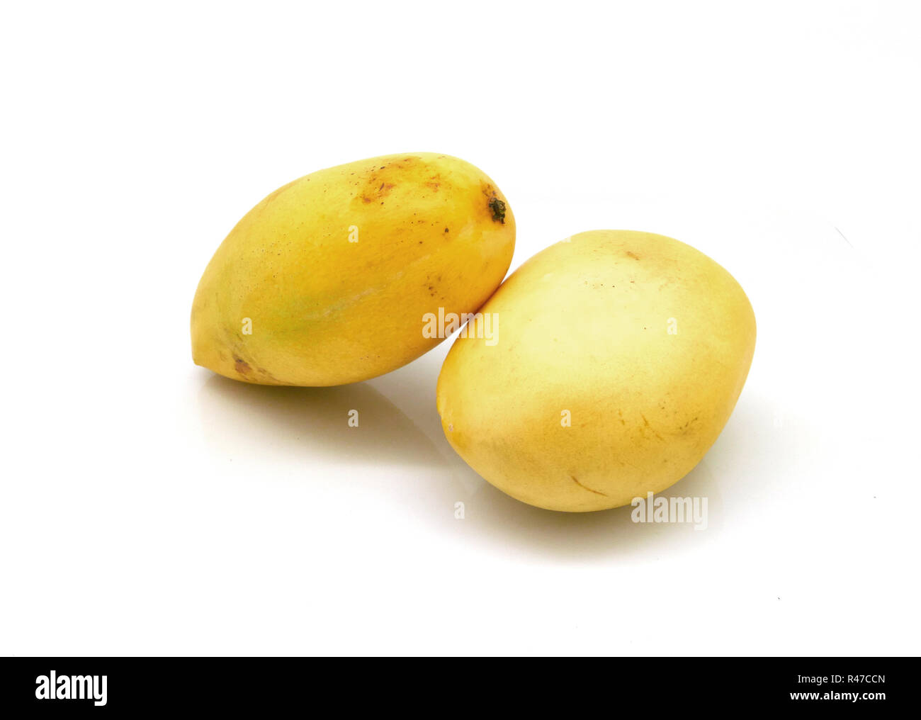 two yellow mangos Stock Photo - Alamy