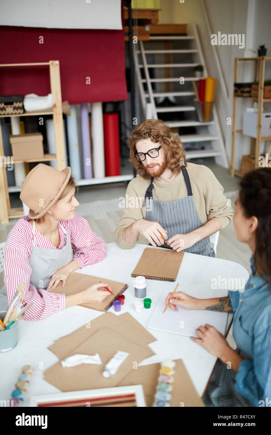 Groupmates by table Stock Photo - Alamy