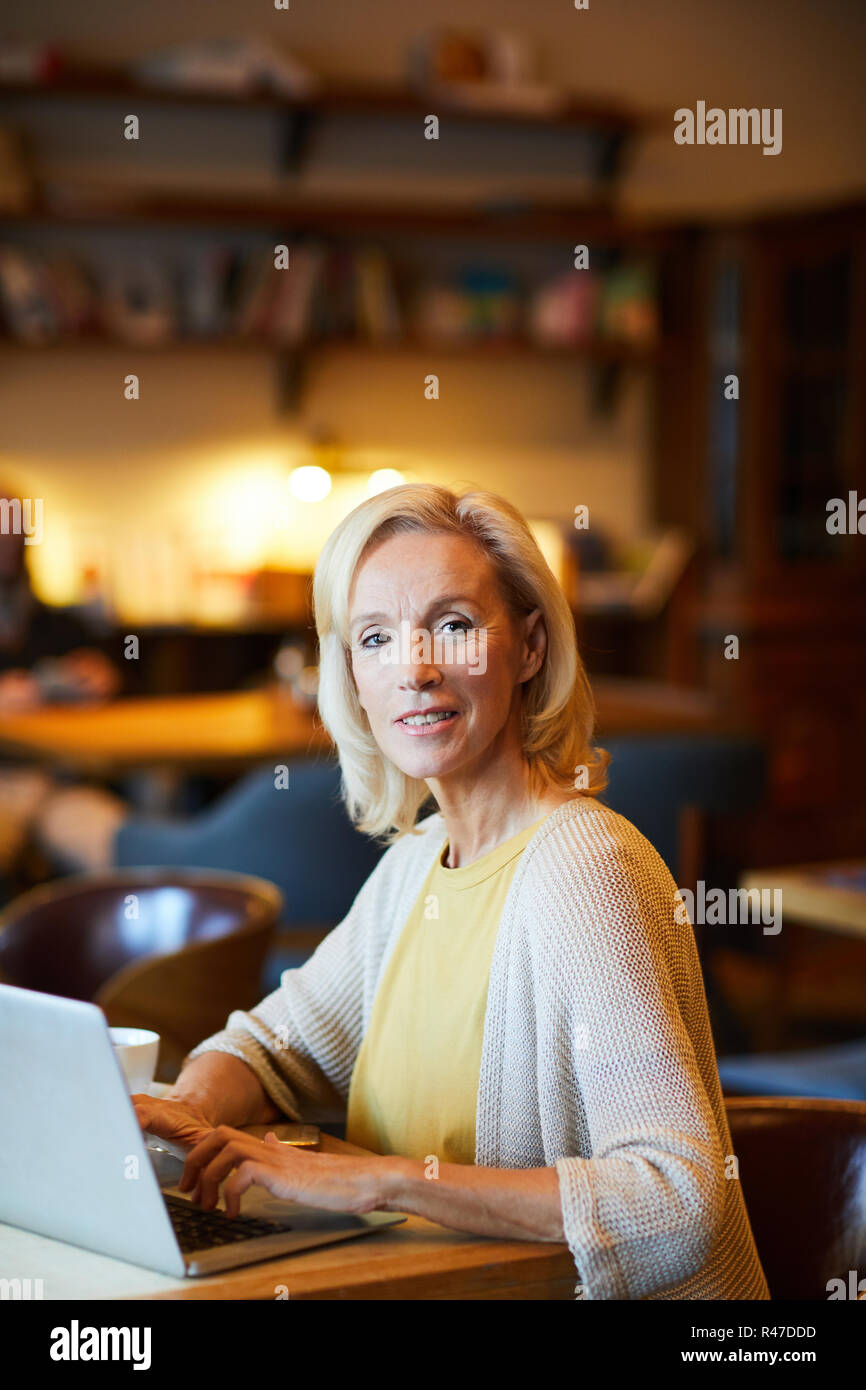Confident mature woman typing hi-res stock photography and images - Alamy