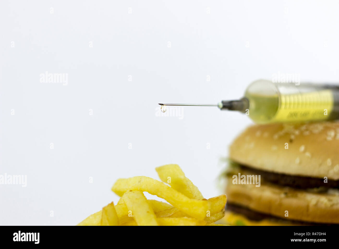 Syringe on a hamburger Stock Photo - Alamy