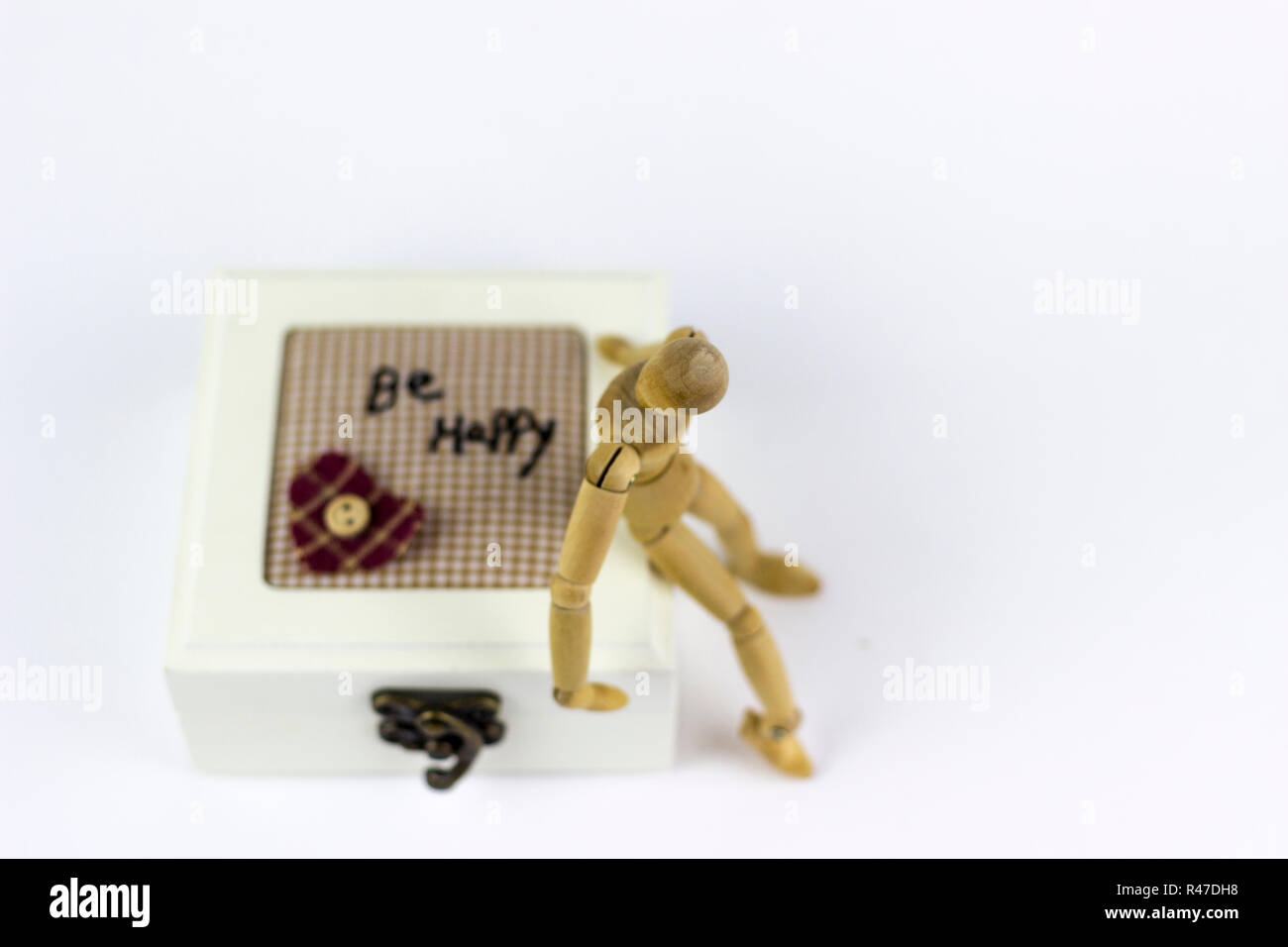 Wooden puppet sitting on a jewellery box Stock Photo - Alamy