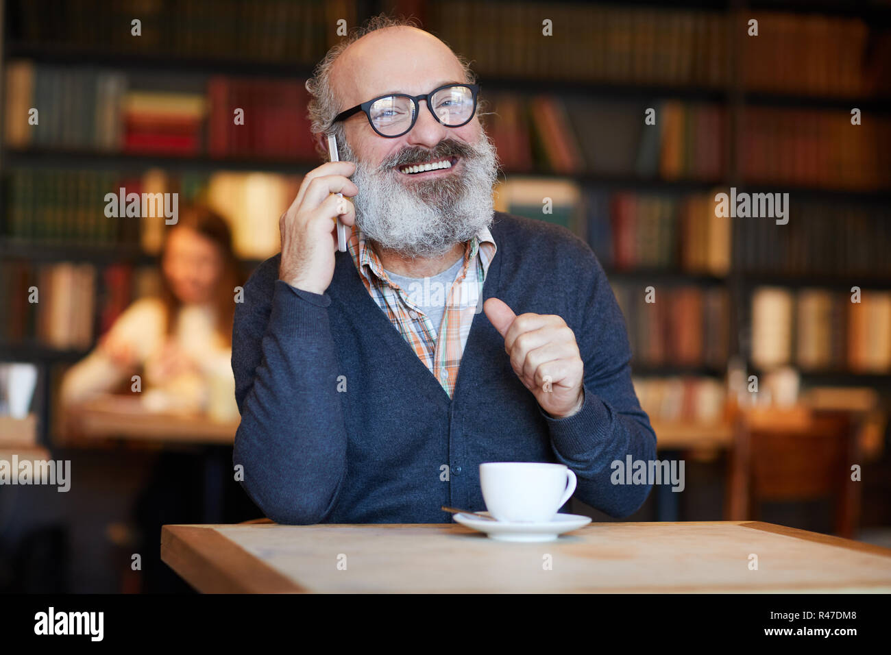 Businessman phoning his smartphone cafe hi-res stock photography and ...