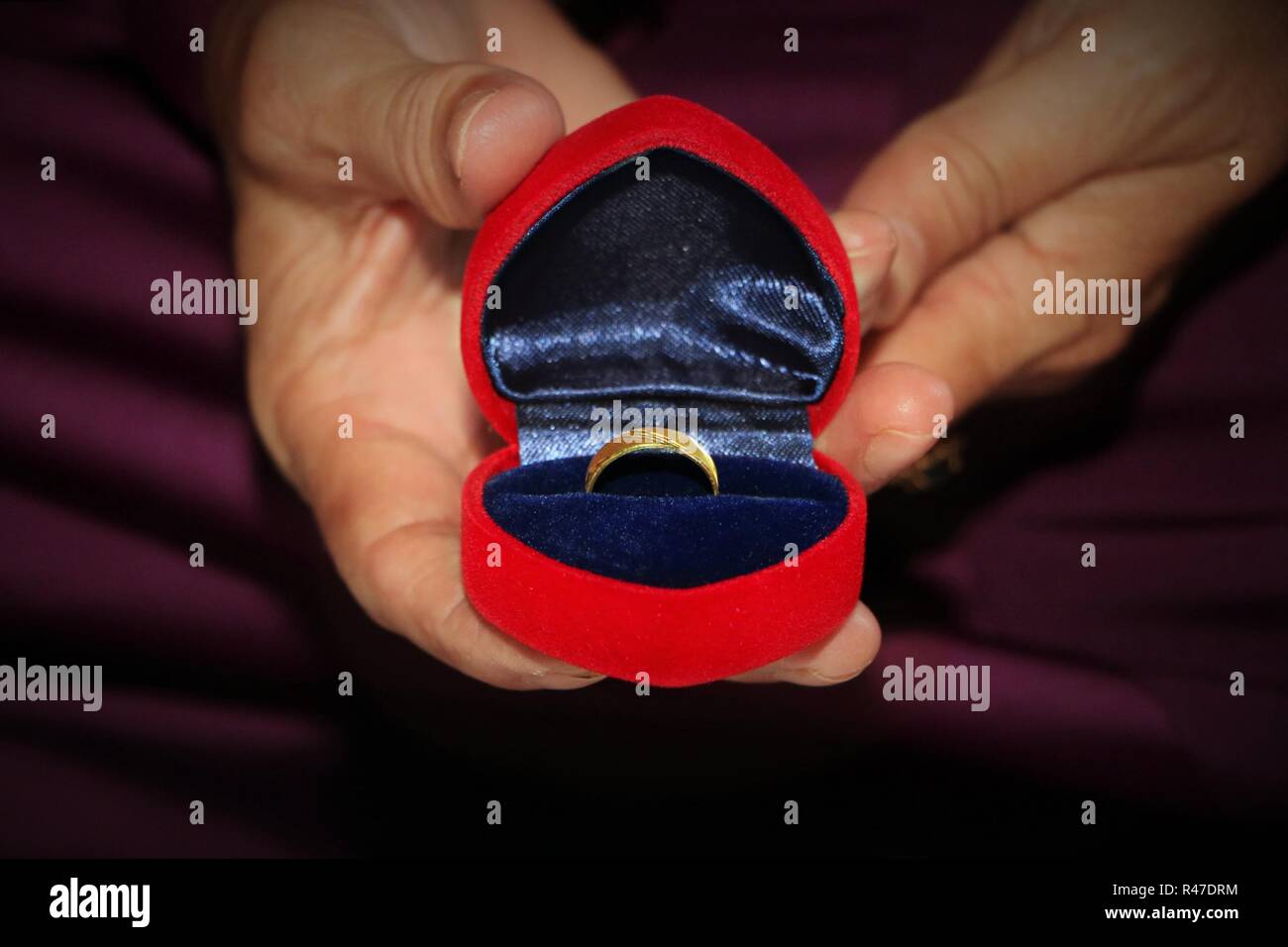 Hand holding engagement ring Stock Photo - Alamy