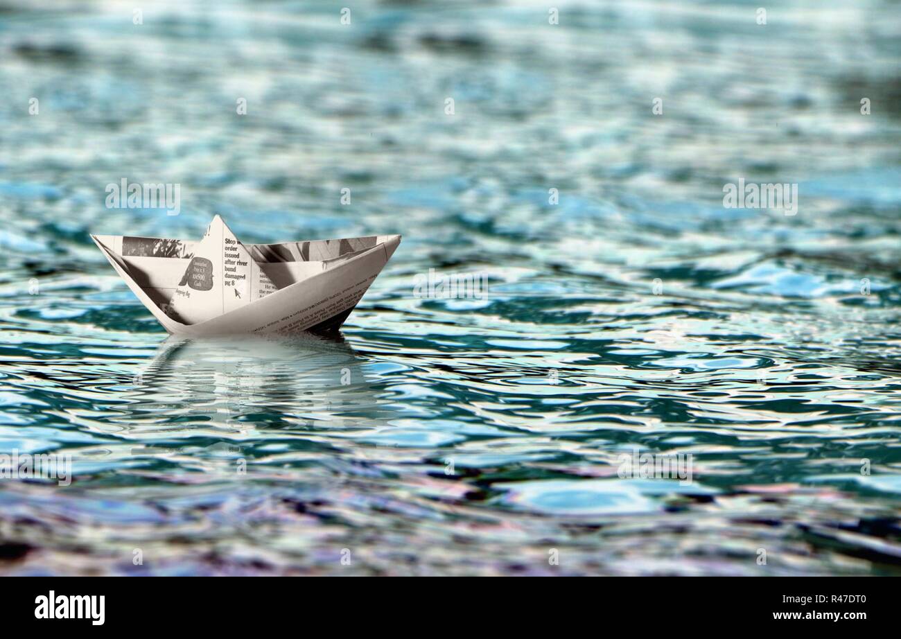 Paper boat floating on water Stock Photo - Alamy