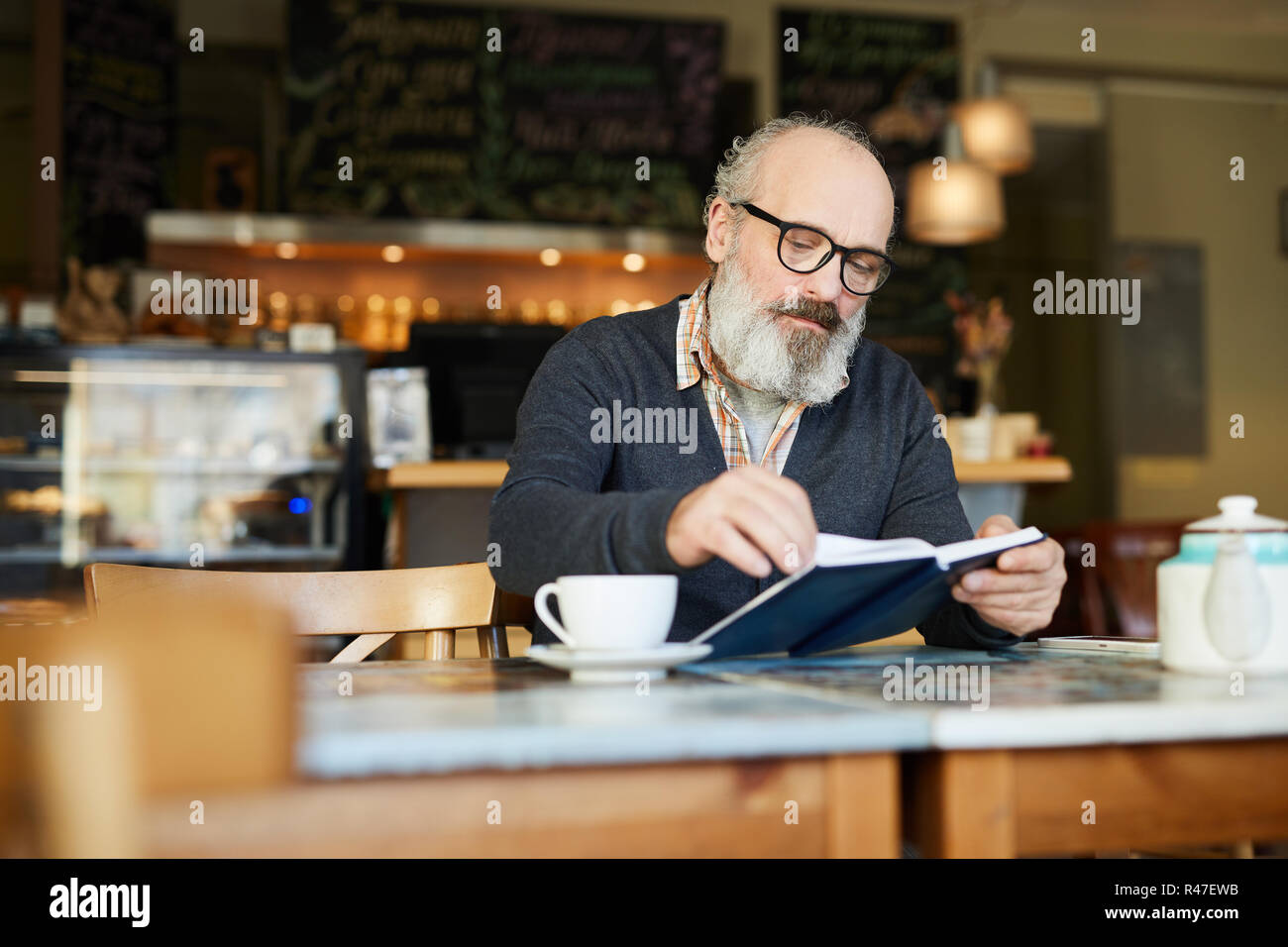 Cafe man serious hi-res stock photography and images - Alamy