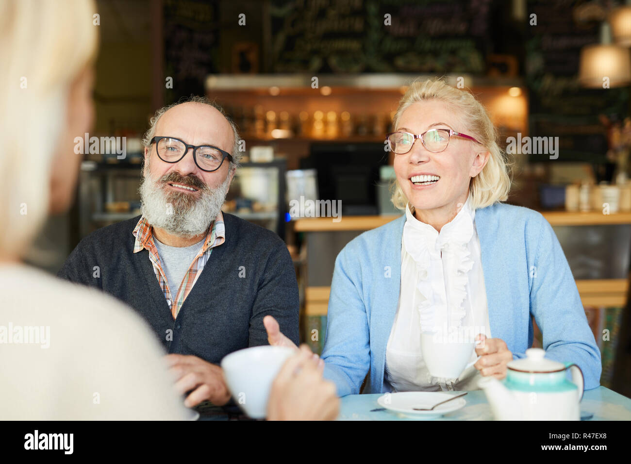 Seniors talking by cup of tea Stock Photo - Alamy