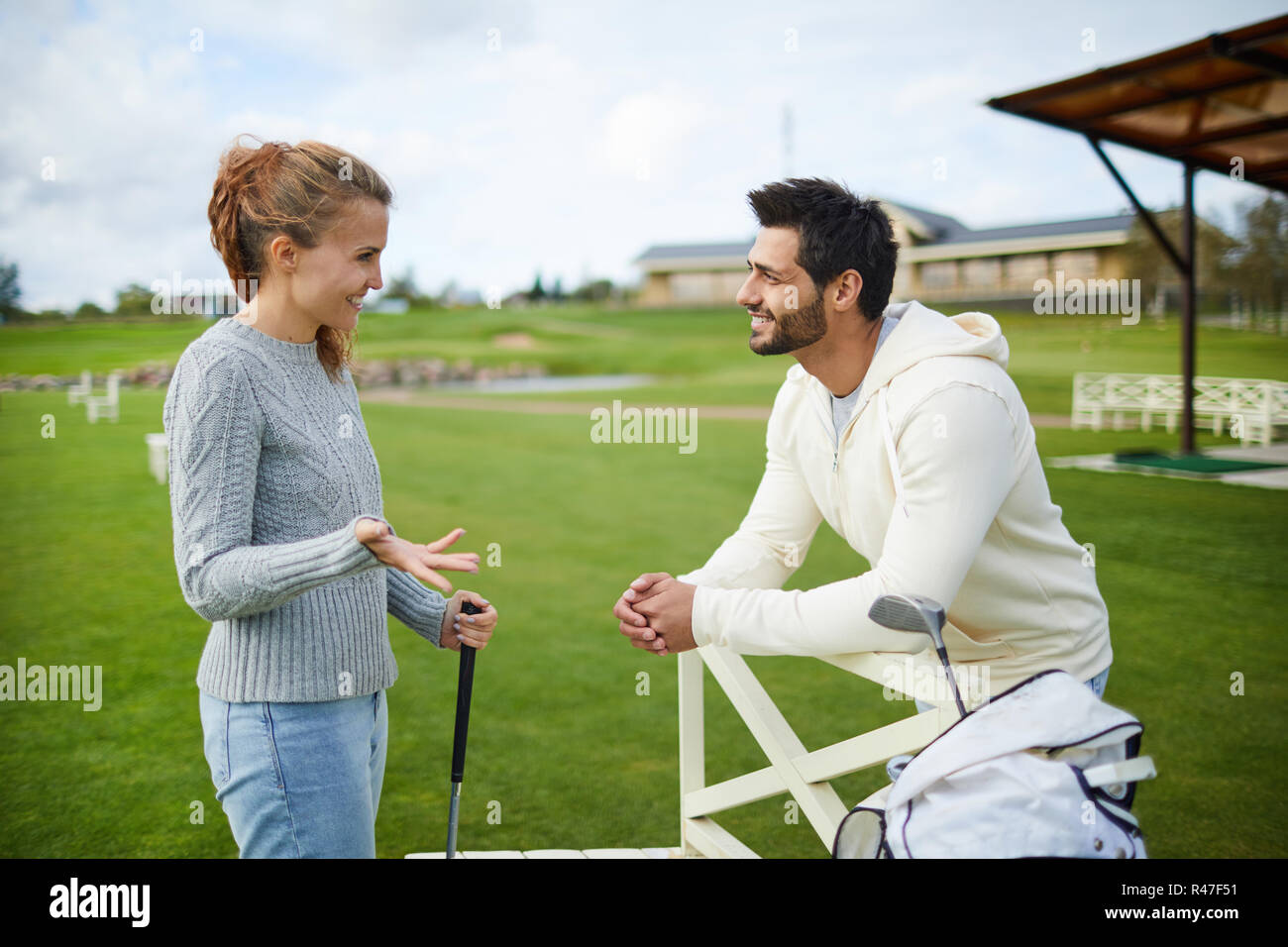 Golf players talking Stock Photo - Alamy
