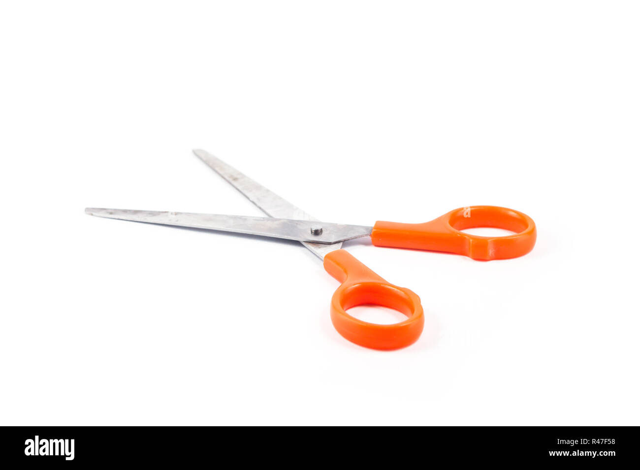 Orange scissors isolated on white background Stock Photo - Alamy