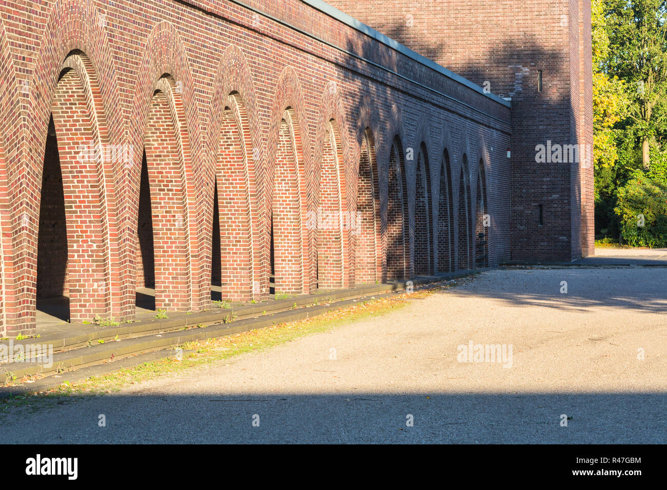 building with round arches of brick Stock Photo - Alamy