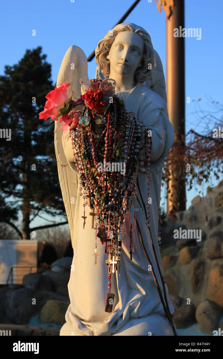 Angels holding armfuls of rosaries left as mementos of private requests ...