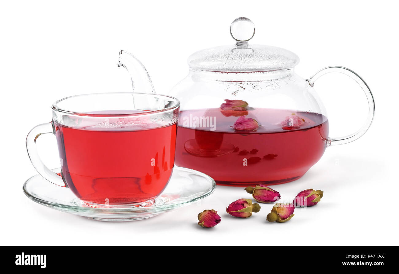 Fresh brewed rose tea in a glass teapot and a cup and a few buds of a ...