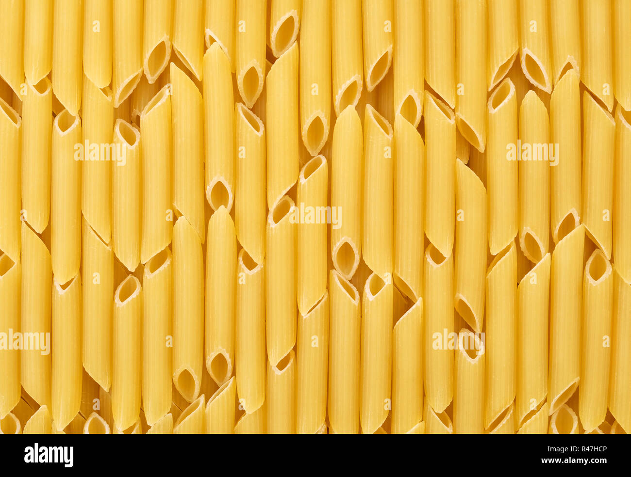 Italian uncooked pasta penne sorted vertically for background or ...