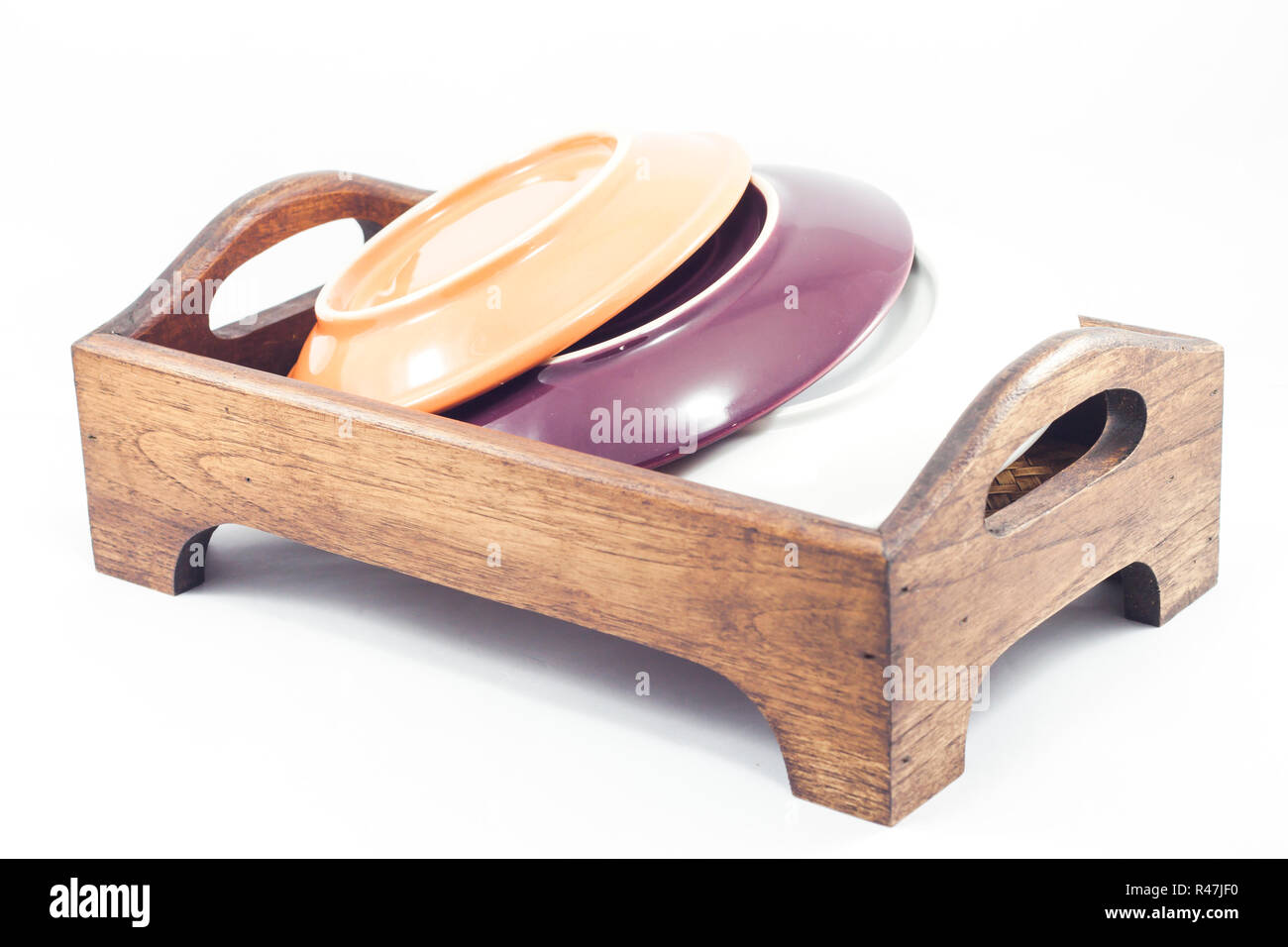Plates on wooden tray isolated on white background Stock Photo - Alamy