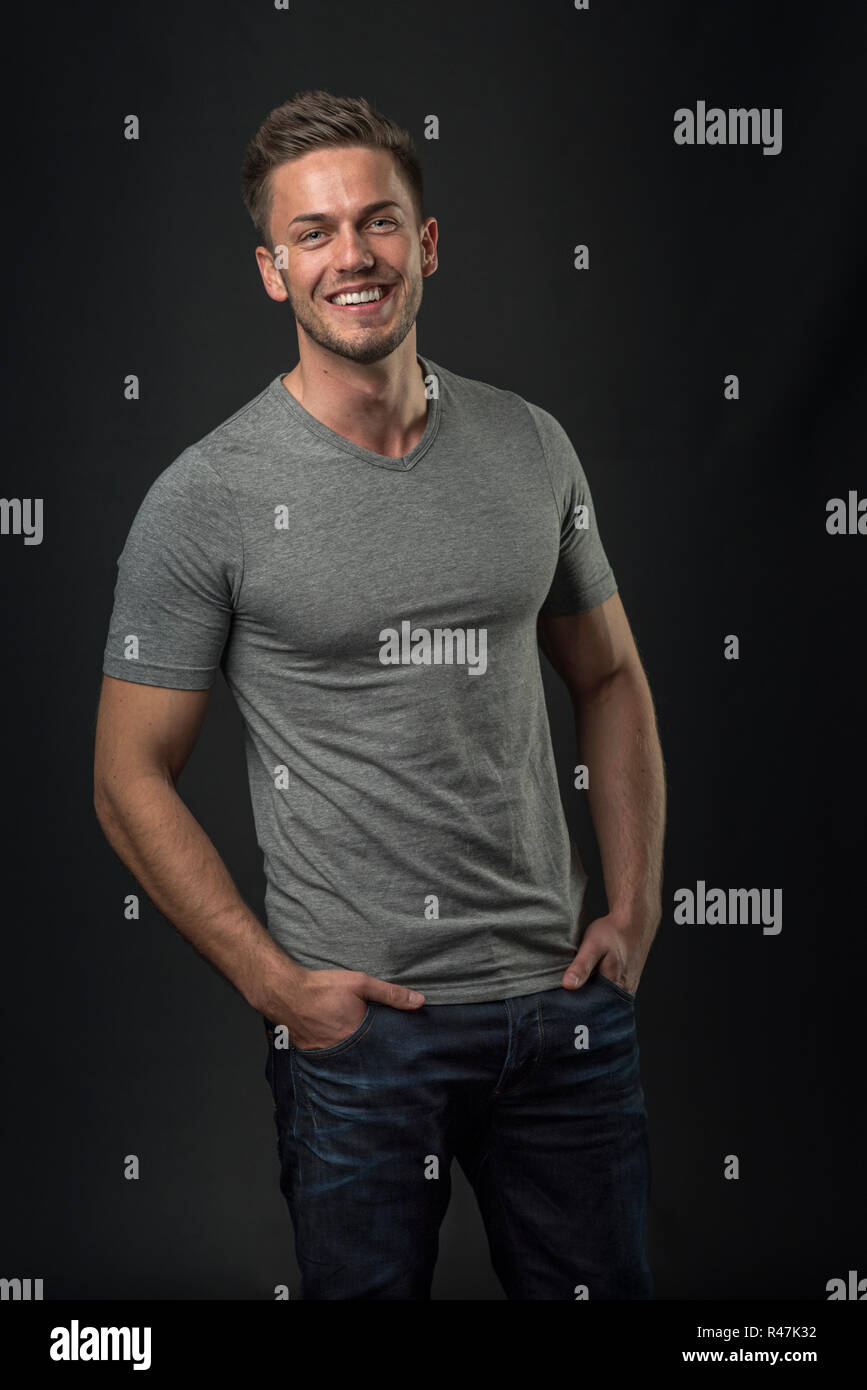 smiling dream man in jeans Stock Photo - Alamy