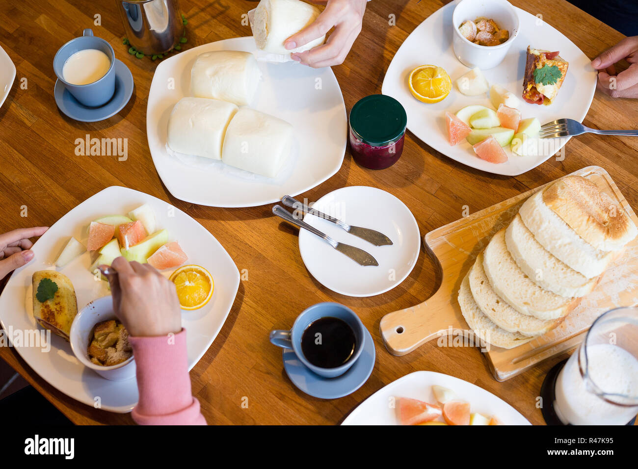 Group of people having breakfast together Stock Photo - Alamy