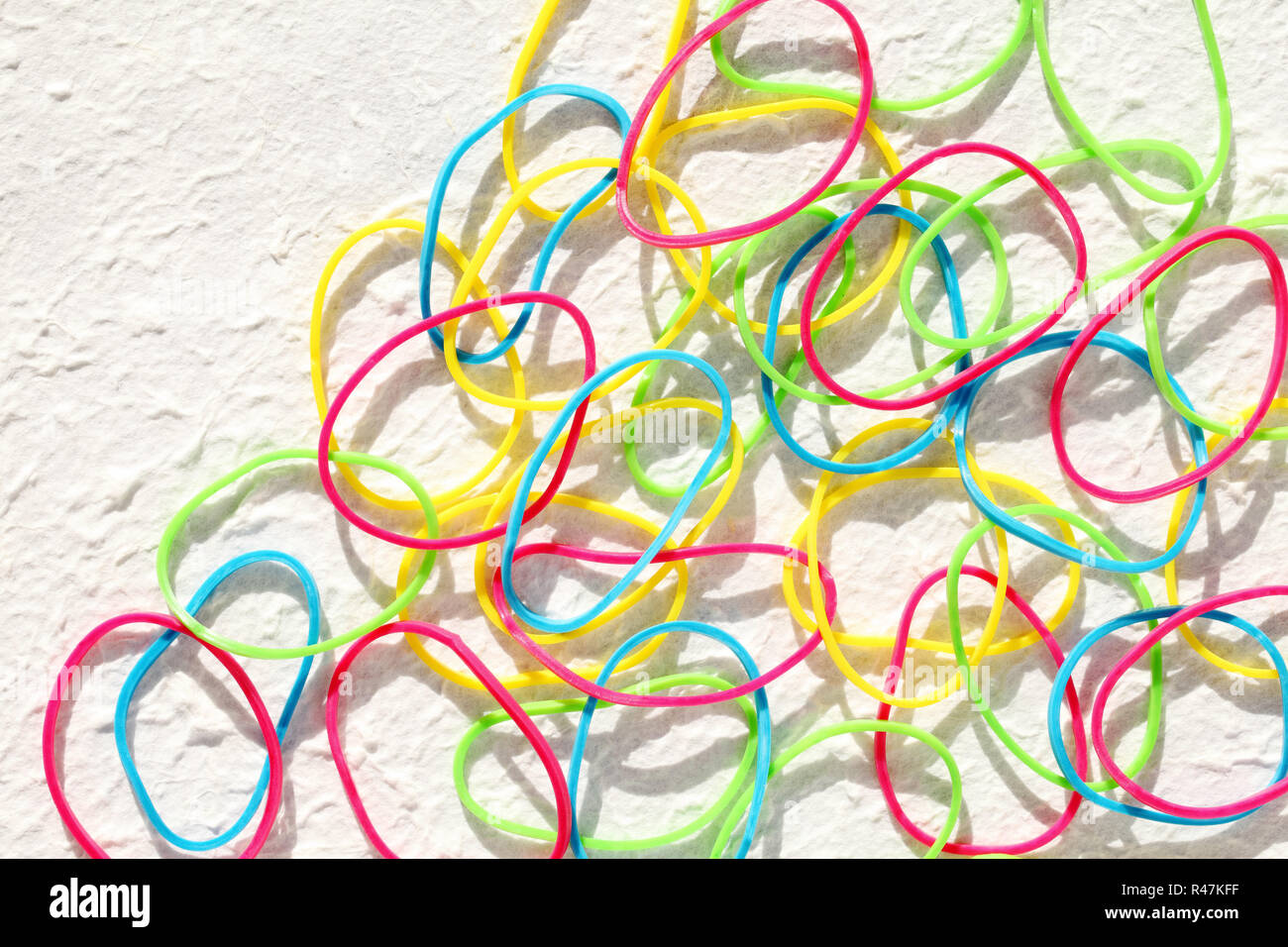 Colorful rubber bands on white background Stock Photo - Alamy