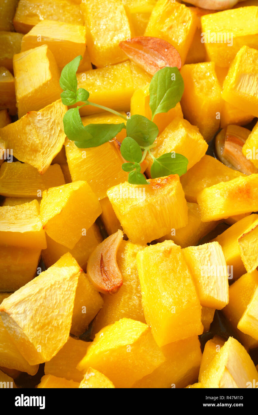 Diced pumpkin roasted with garlic Stock Photo - Alamy