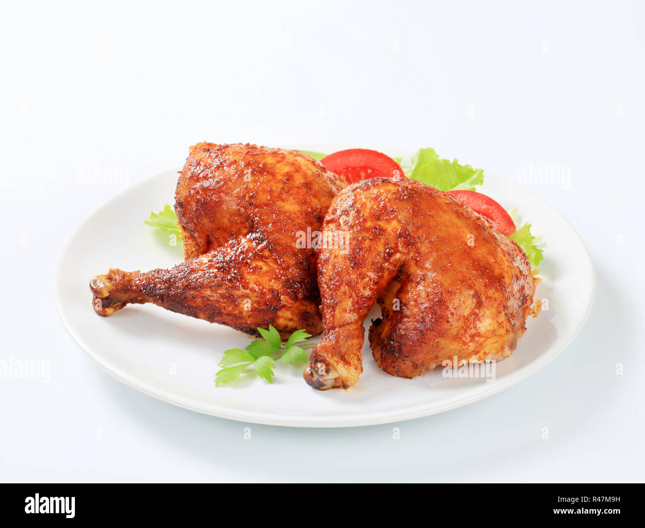 Garlic roasted chicken legs Stock Photo - Alamy