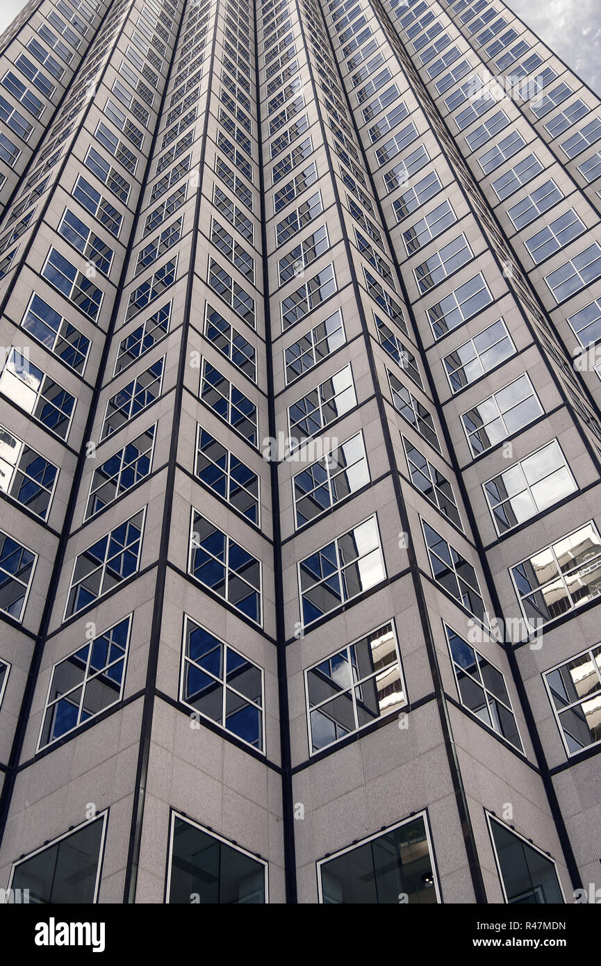 perspective wide angle view to steel blue background of glass high rise ...