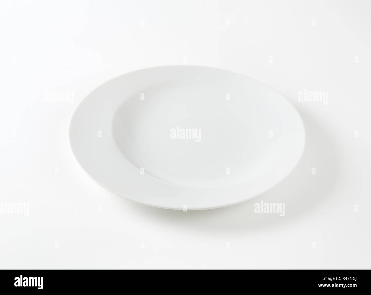 Irregular rim dinner plate Stock Photo - Alamy