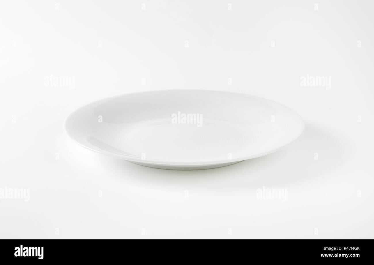 Smooth white dinner plate Stock Photo - Alamy