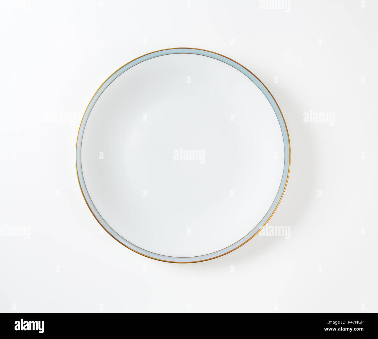 White plate with blue and gold band Stock Photo - Alamy