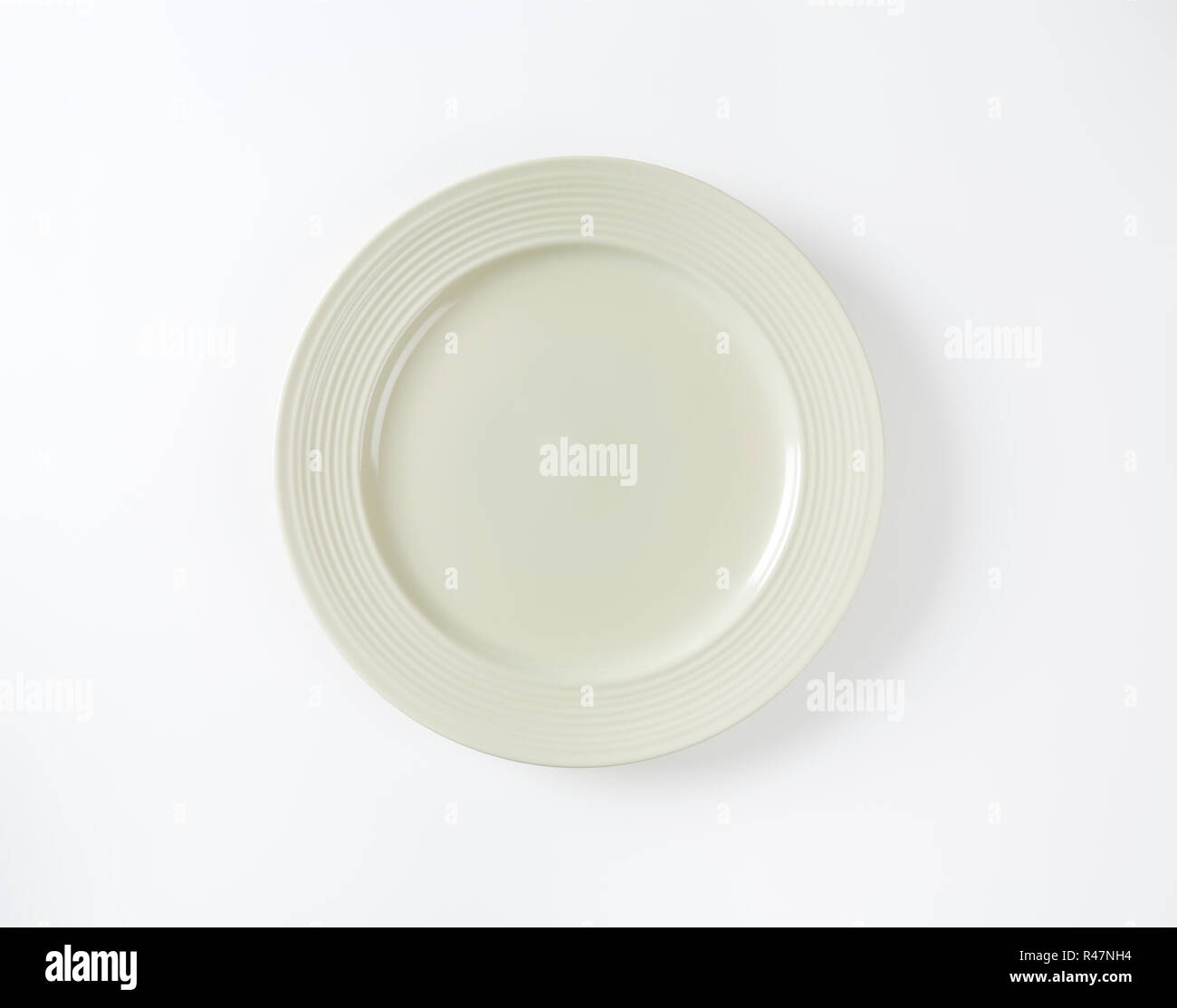 Bone white dinner plate with wide rim Stock Photo - Alamy