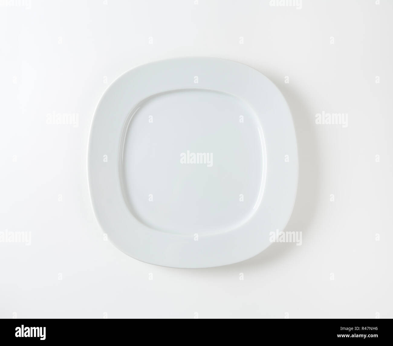 Wide rimmed square plate Stock Photo - Alamy