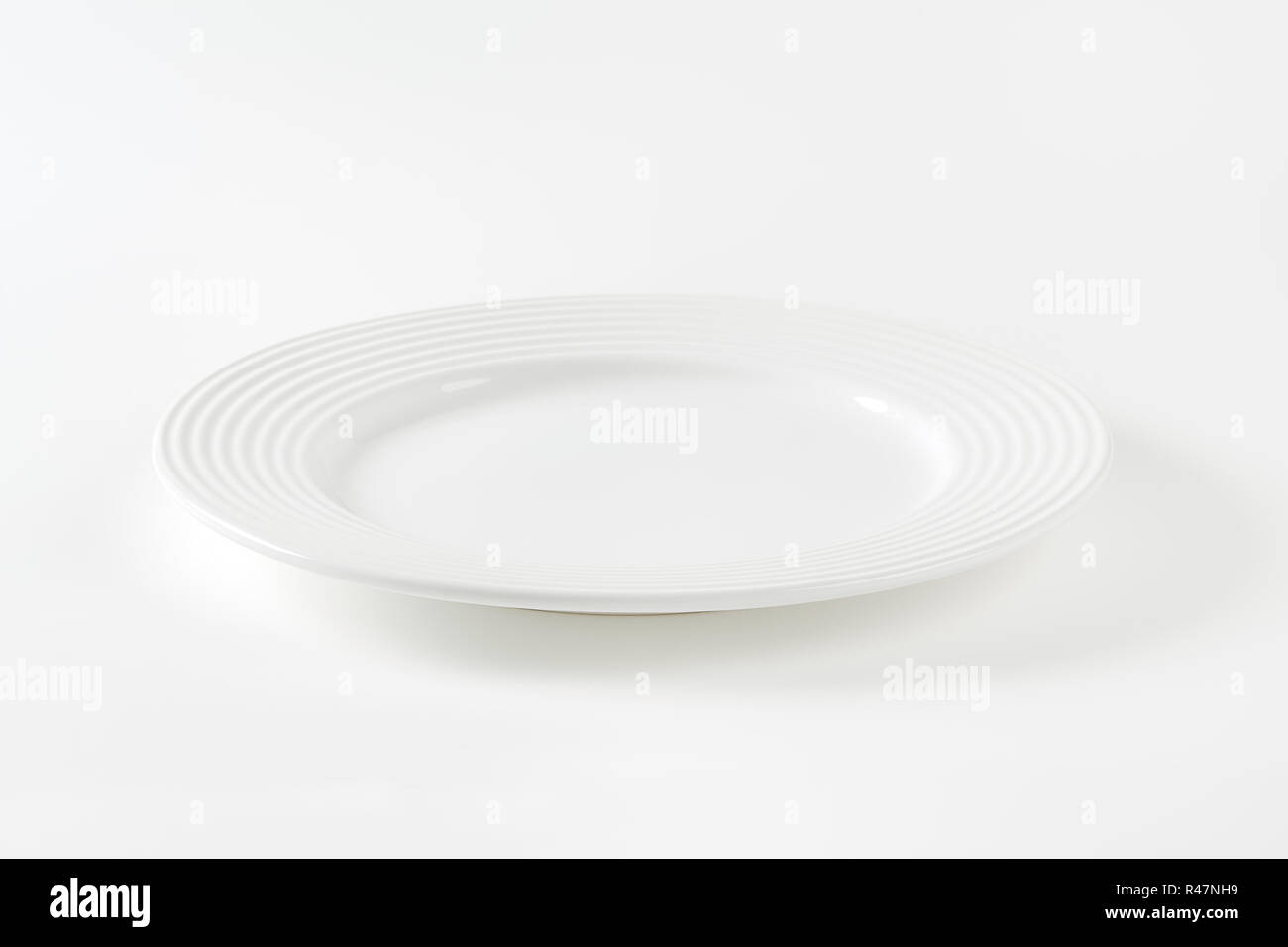 White porcelain plate with wide rim Stock Photo - Alamy