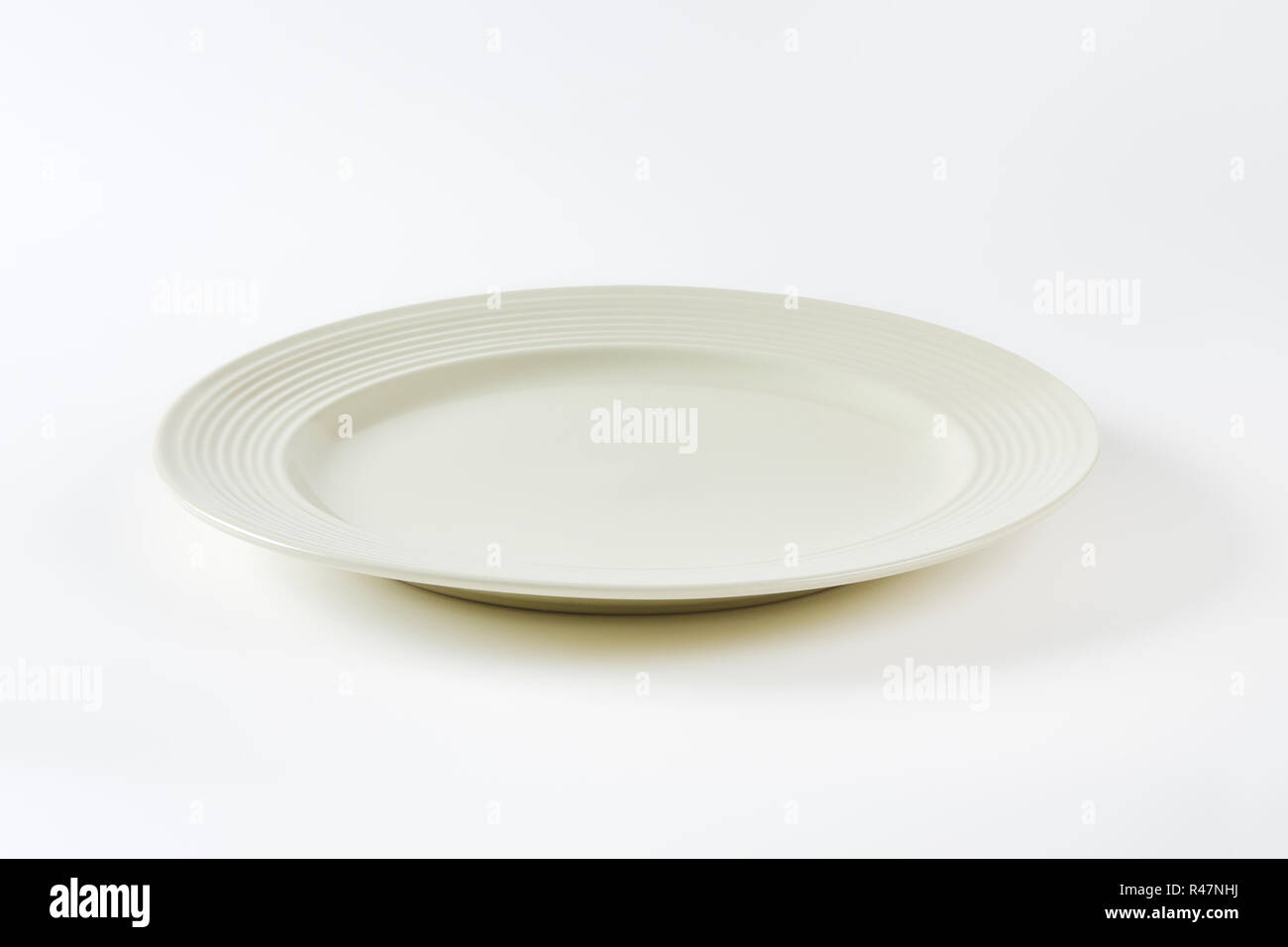 Bone white dinner plate with wide rim Stock Photo - Alamy