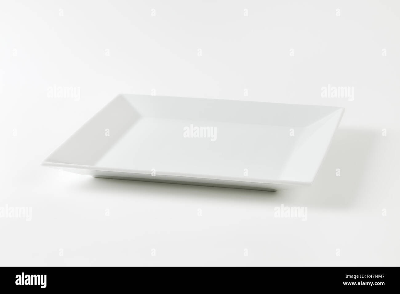 Square white dinner plate Stock Photo - Alamy