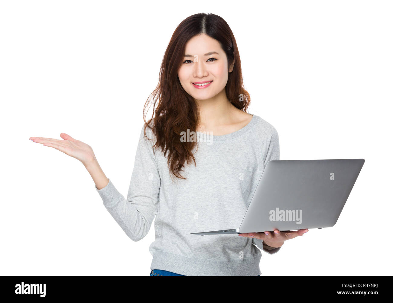 Young Woman hold with laptop computer and open hand palm Stock Photo ...