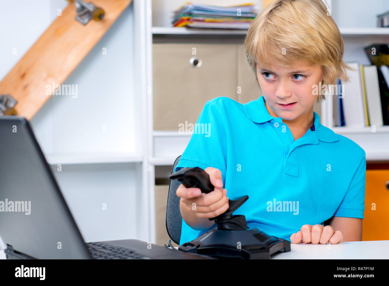 boy is playing computer game Stock Photo - Alamy