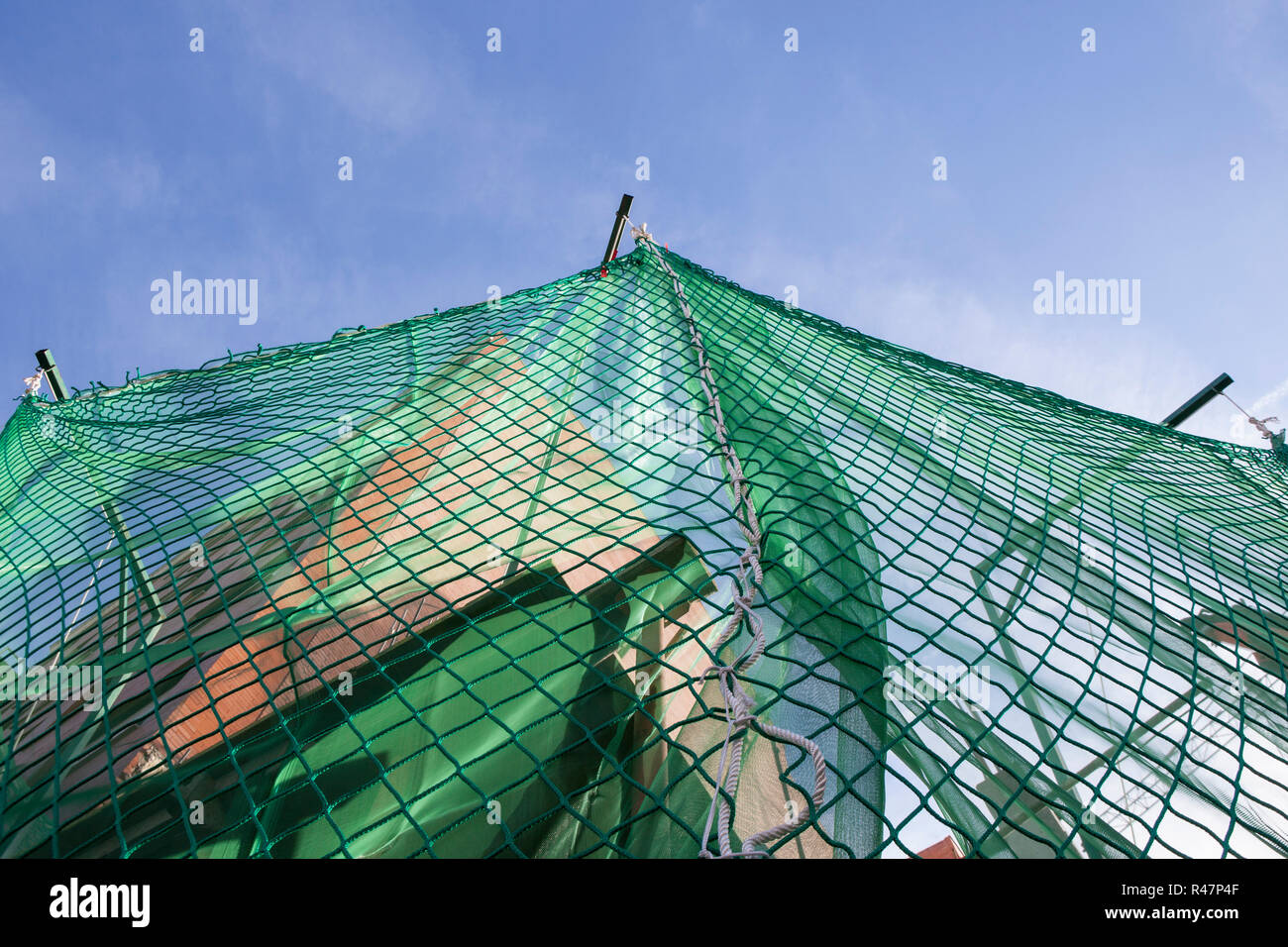 Hanging protection net on building construction site Stock Photo - Alamy
