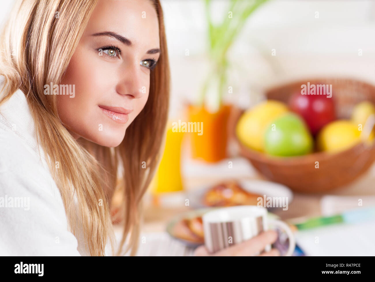 Cute female having morning coffee Stock Photo - Alamy