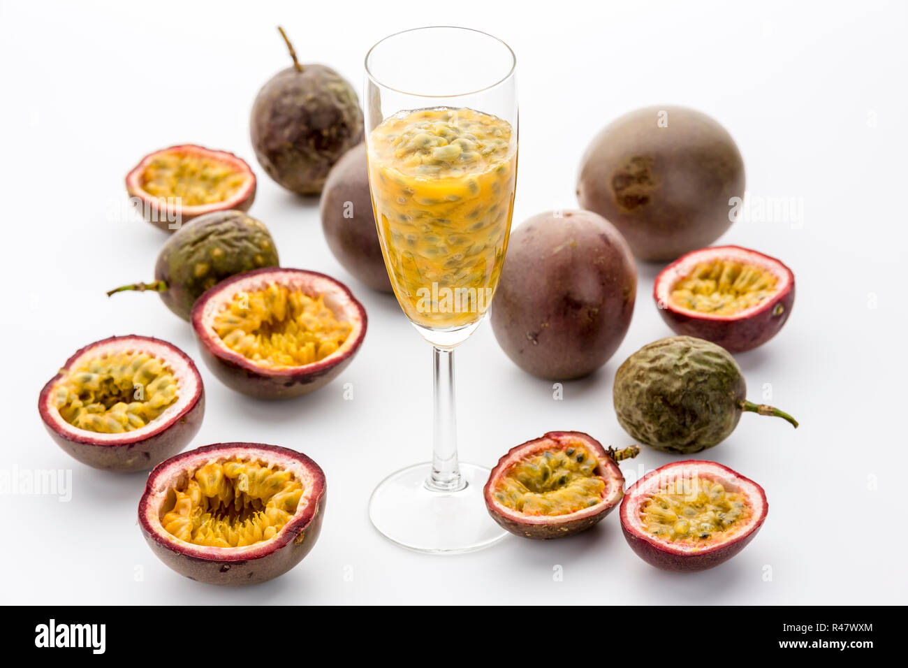 Passion Fruit Flesh In A Flute Amidst Cut Fruits Stock Photo - Alamy